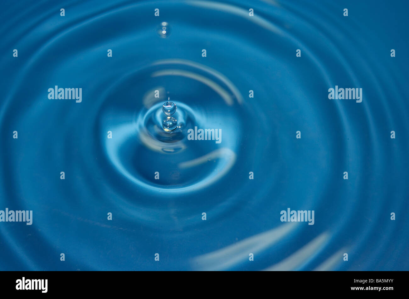 a drip in blue water Stock Photo - Alamy
