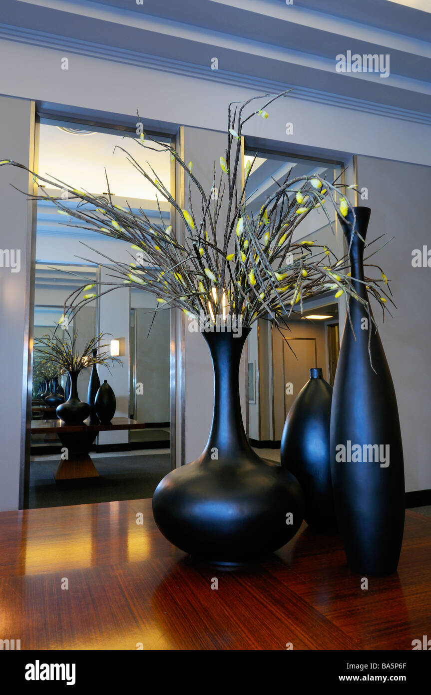 Blue light on flower vases reflected infinitely in mirror room of the ...