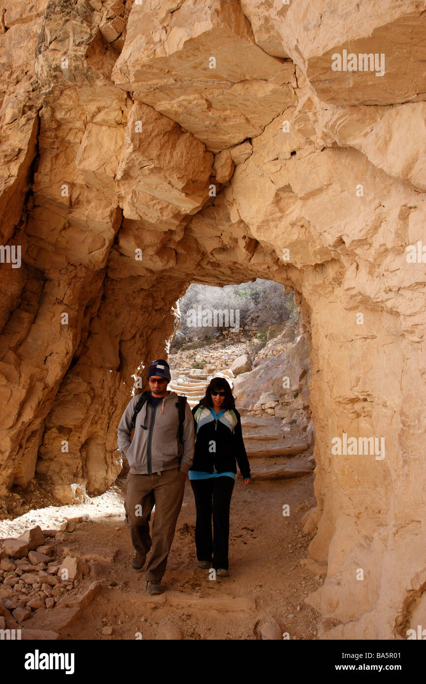 hikers go through a rock tunnel on the bright angel trail grand canyon ...
