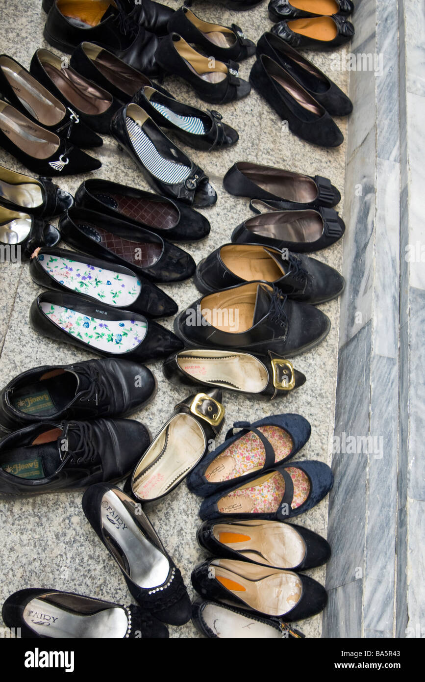Empty shoes line up outside temple of the emerald buddha Bangkok ...