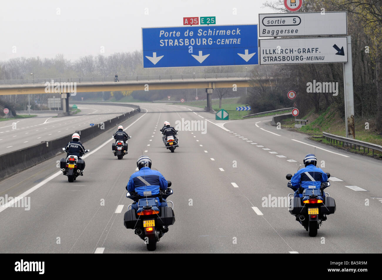 Police officers on motorbike speeding on a highway closed to the public ...