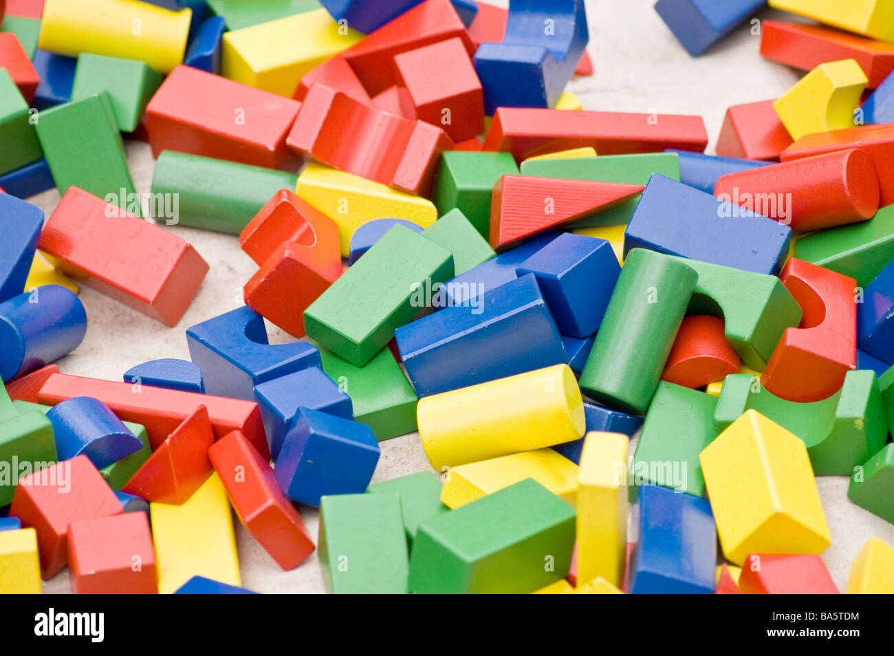 A bunch of colorful, wooden blocks on the floor of a playroom Stock ...