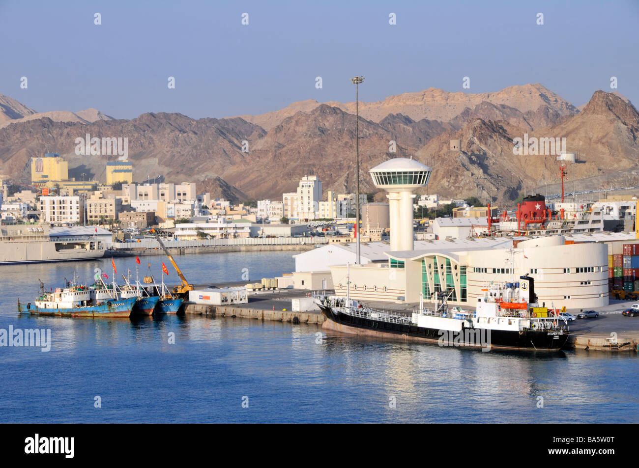 Rocky landscape waterfront and Port Sultan Qaboos at Muttrah also spelt ...