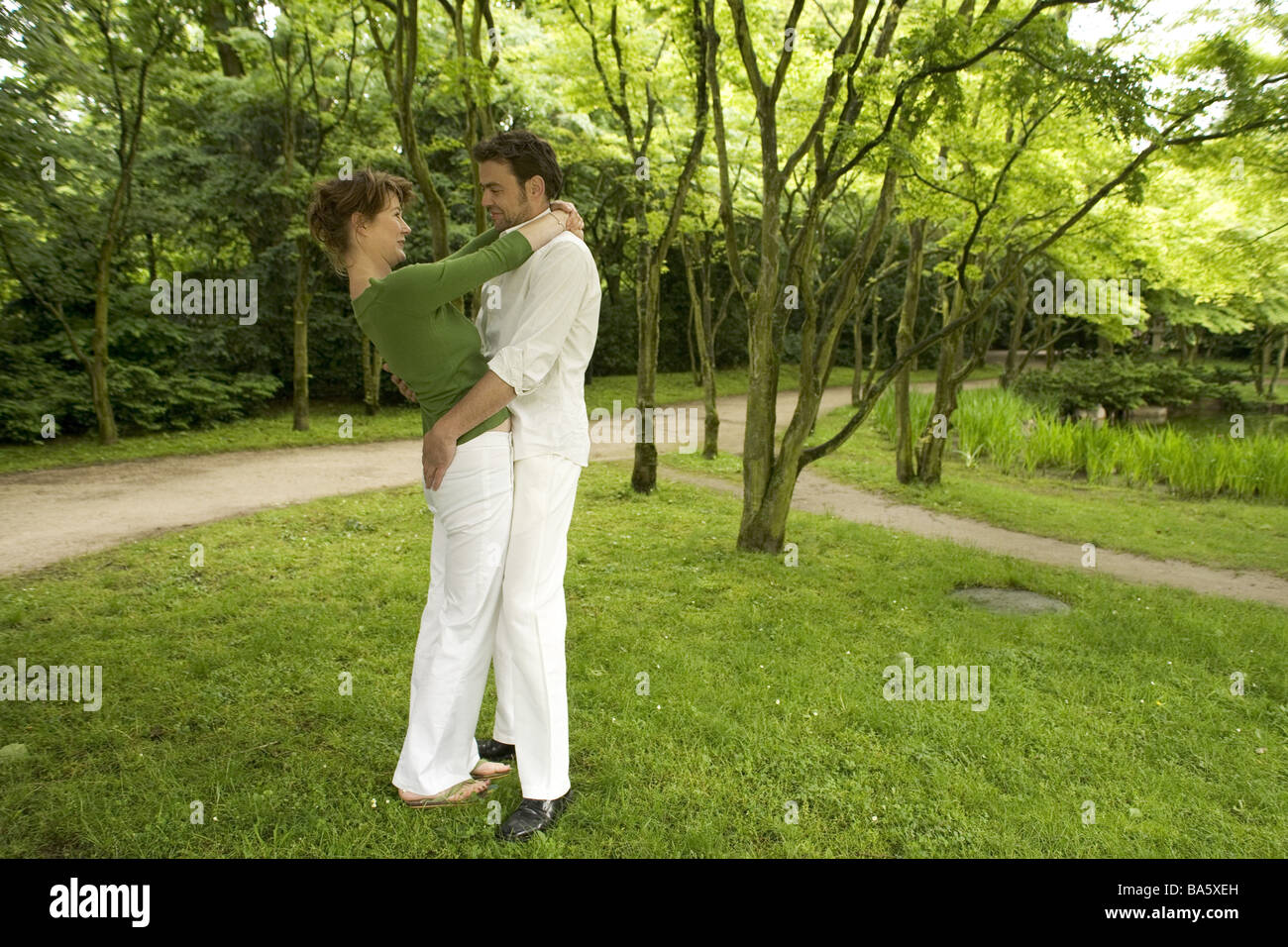 Park pair falls in love embrace at the side series people 30-40 years ...