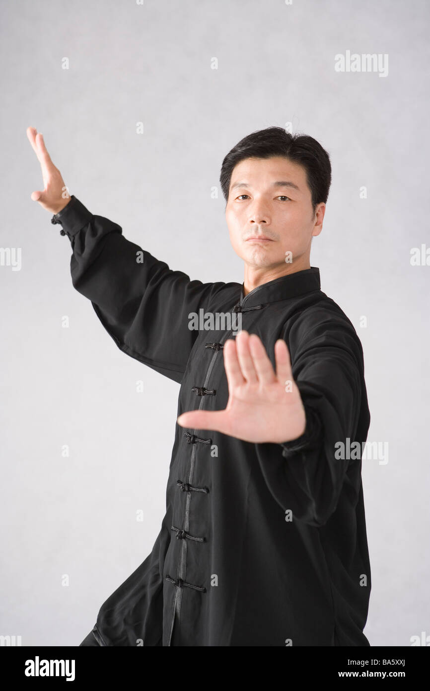 Portrait of man posing in Tai Chi position Stock Photo - Alamy