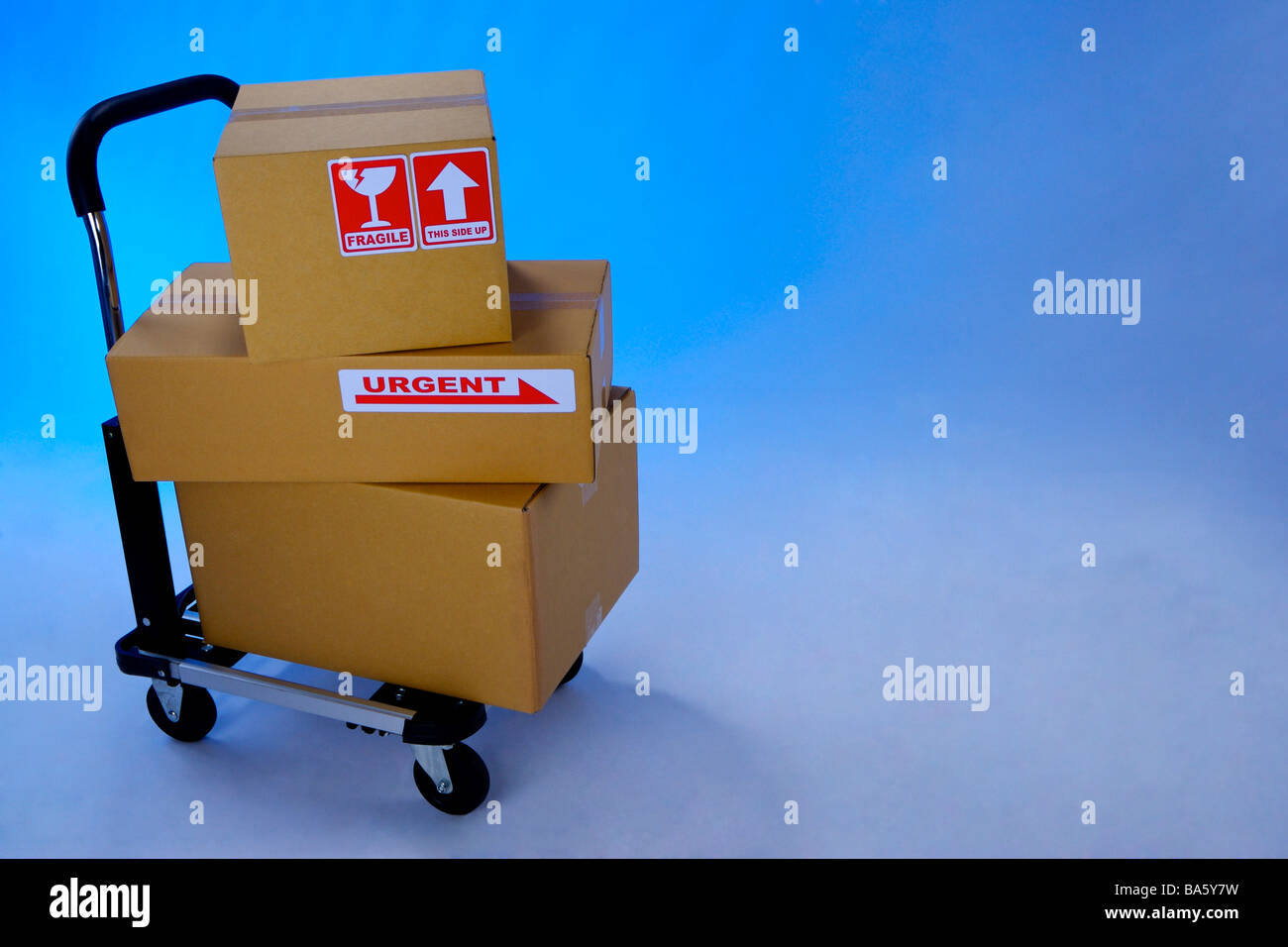 Cardboard boxes on push cart Stock Photo - Alamy