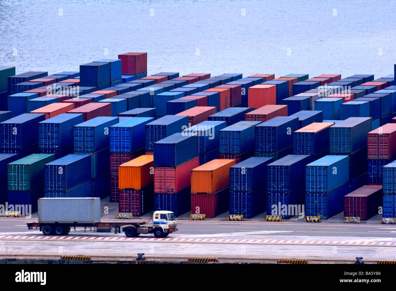 Cargo containers and semi truck at commercial dock Stock Photo - Alamy
