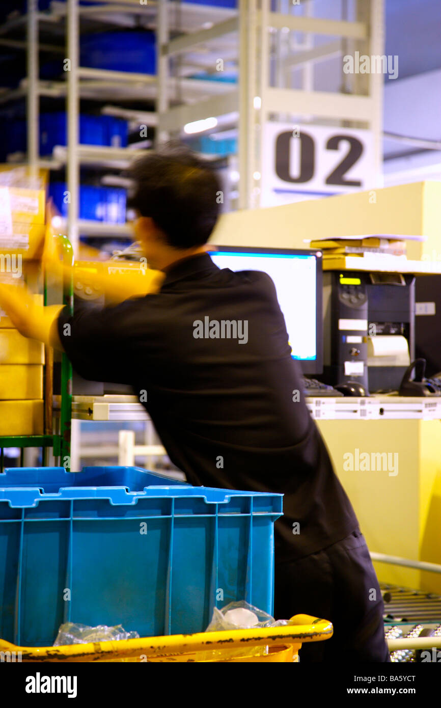 Man working in warehouse Stock Photo - Alamy