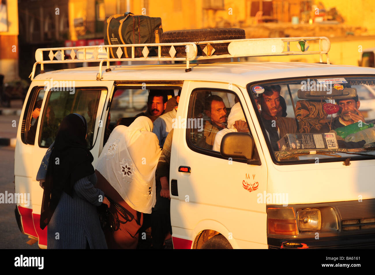 Egypt Aswan people baord a mini van bus for transportation home Stock ...