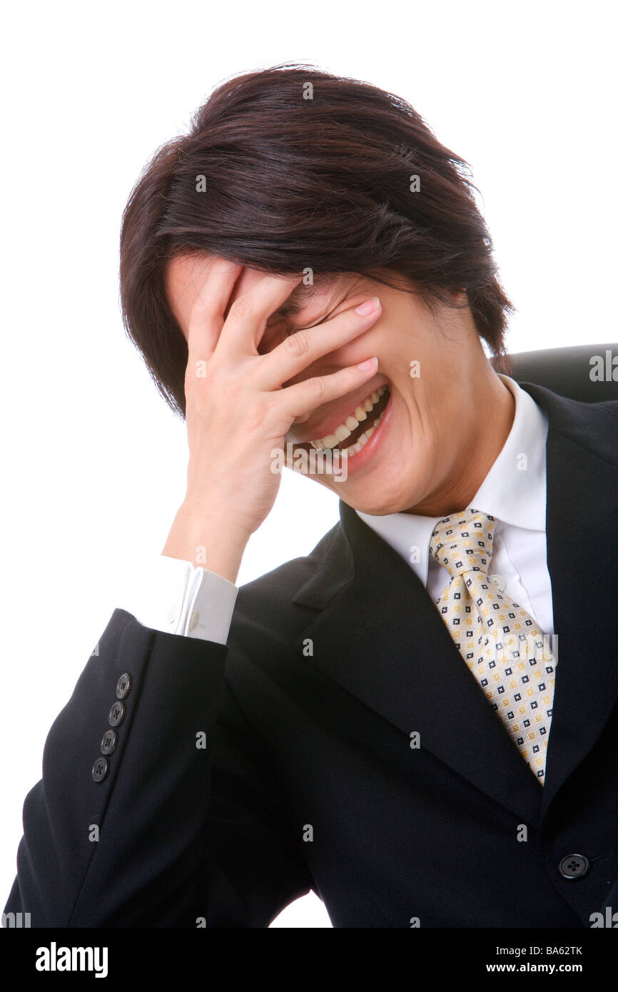 Businessman laughing with hand covering face Stock Photo - Alamy