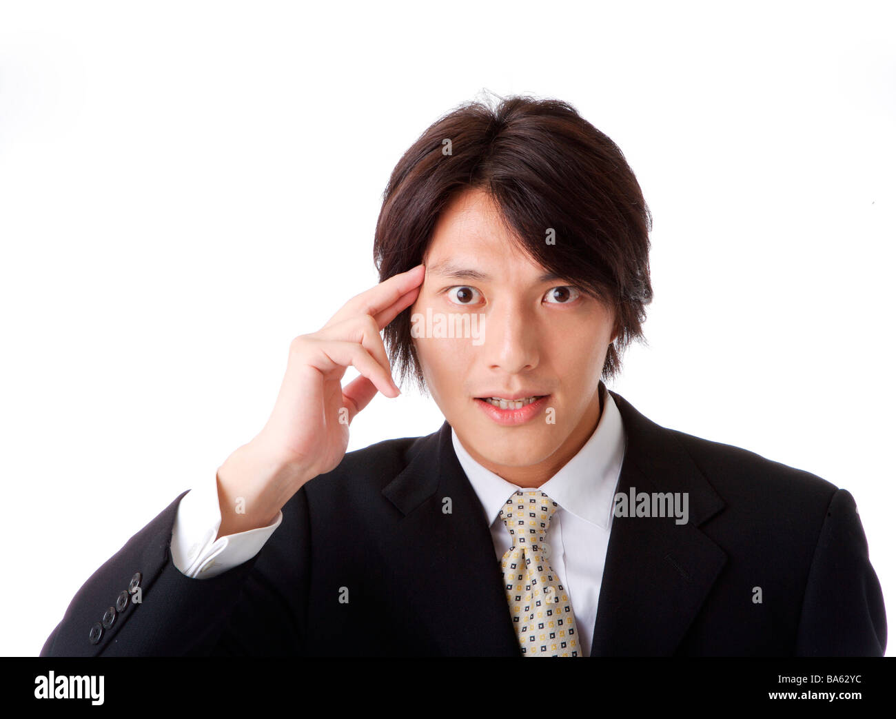 Businessman pointing his temple with two fingers Stock Photo - Alamy