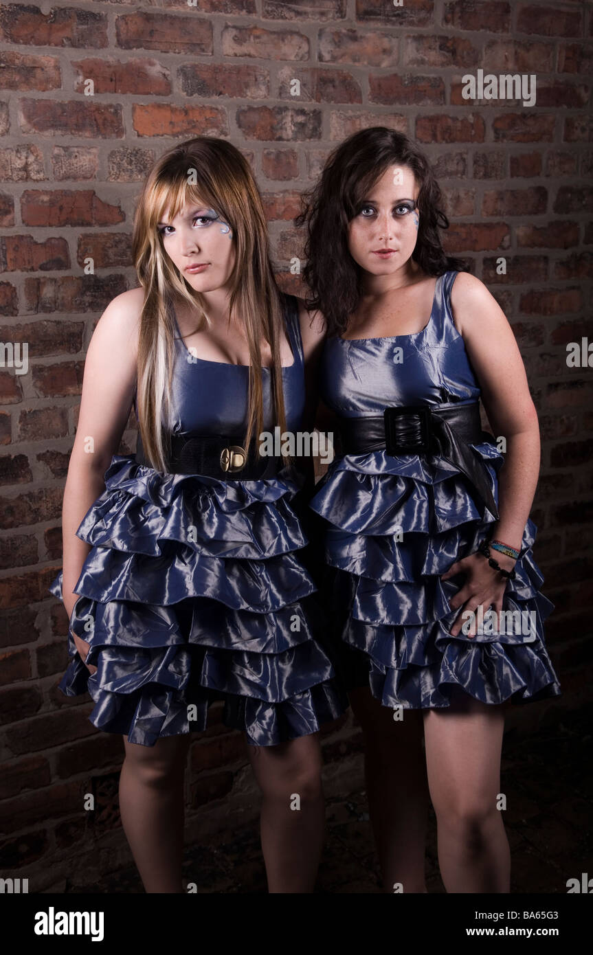 Two young women wearing similar shiny dresses Stock Photo - Alamy