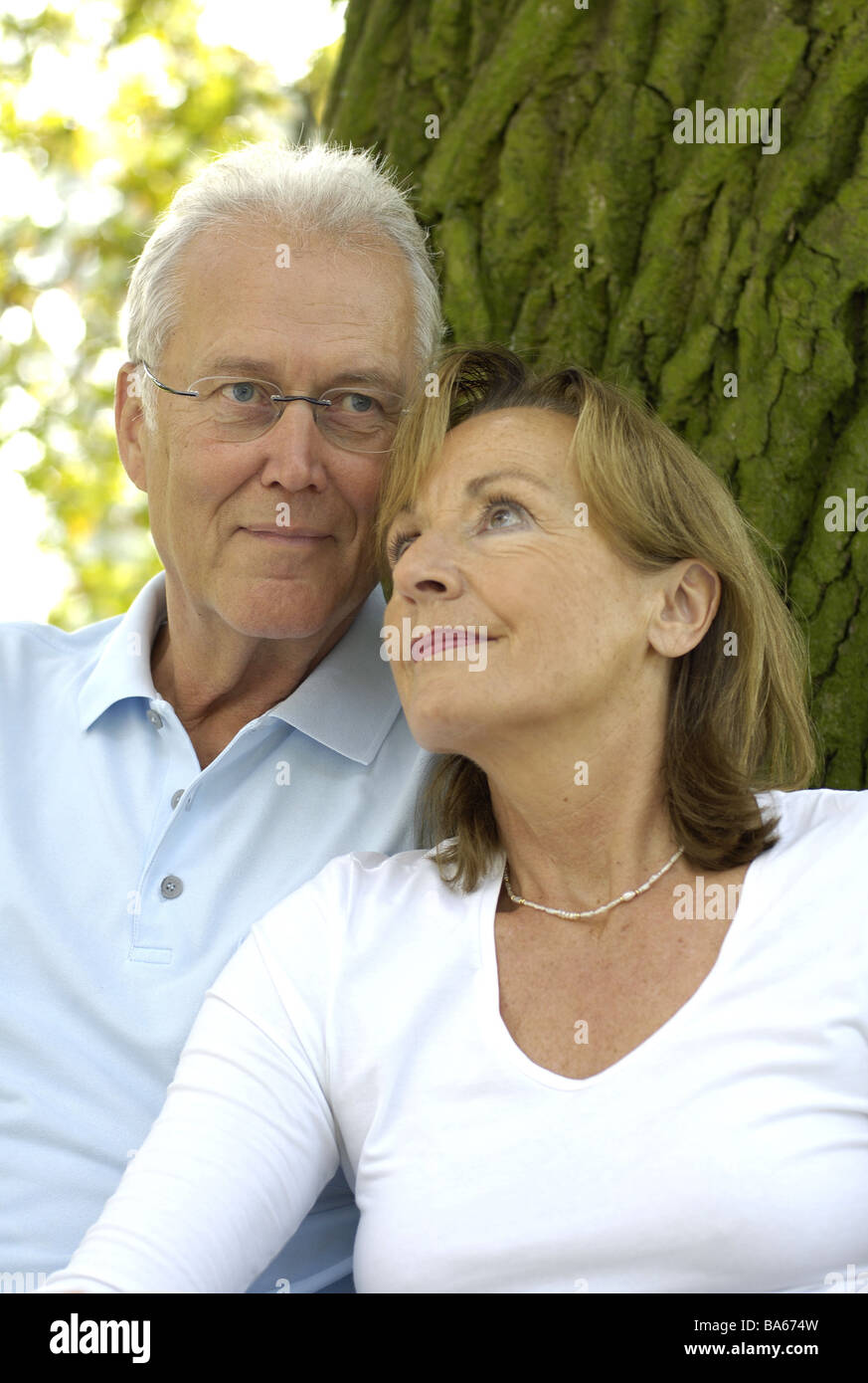Sits garden senior-pair tree leans cheerfully semi-portrait series ...