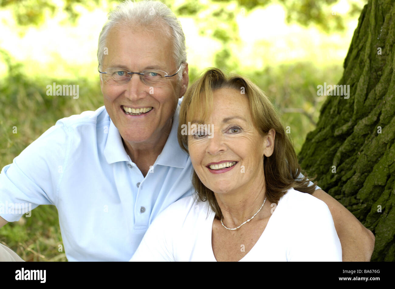 Sits garden senior-pair tree leans cheerfully portrait series people 50 ...