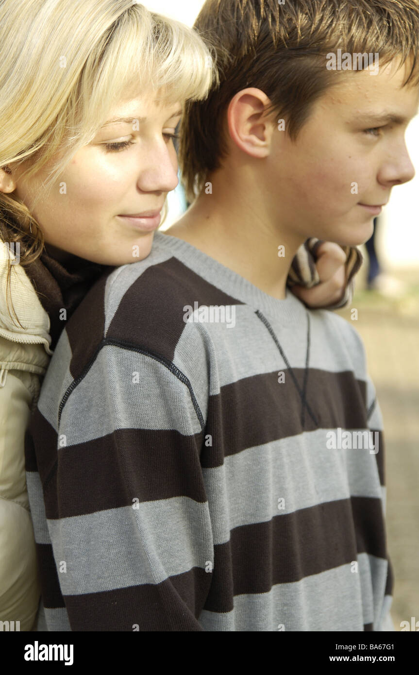 Fallen in love teenagers pair stands consecutively broached at the side ...