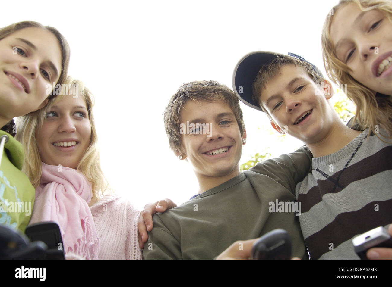 Teenagers clique activity cell phones group-picture broached from below ...
