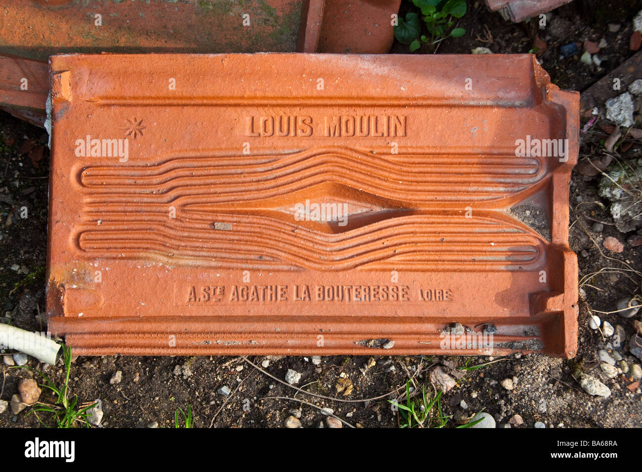 Louis Moulin roof tile lying on the floor in France Stock Photo - Alamy