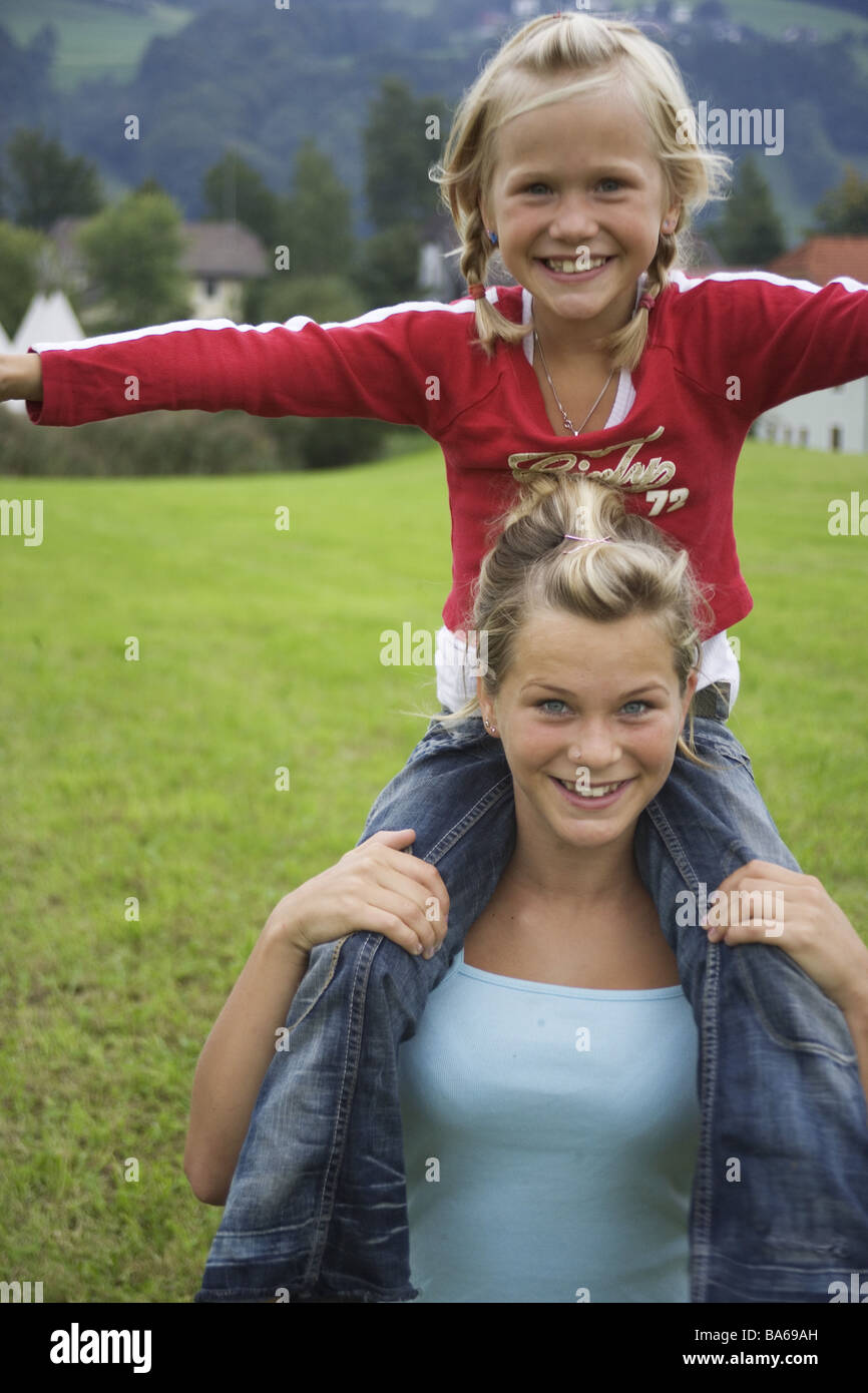 Sisters cheerfully shoulders sits carries semi-portrait broached people ...