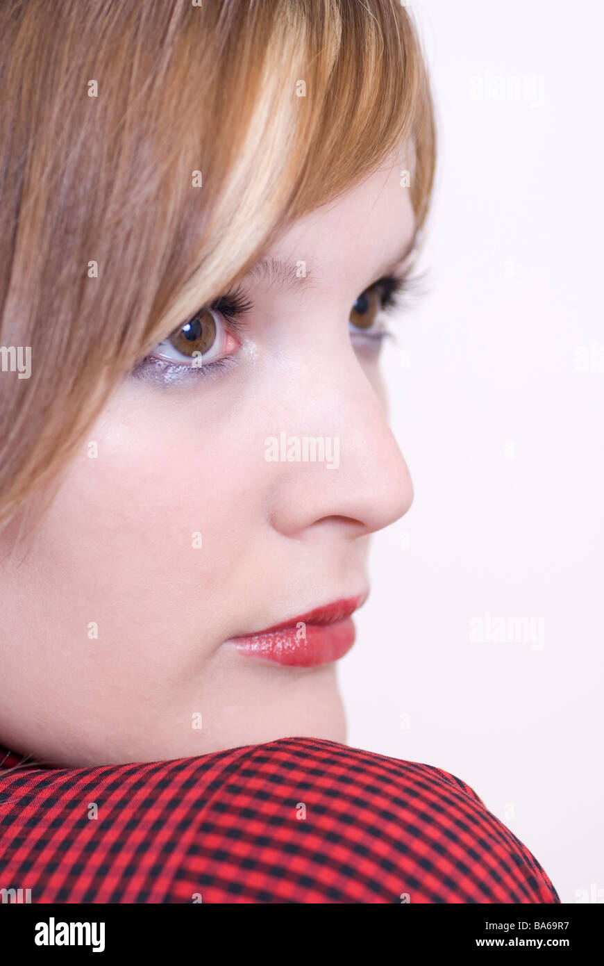 Beautiful young woman looking over shoulder Stock Photo - Alamy