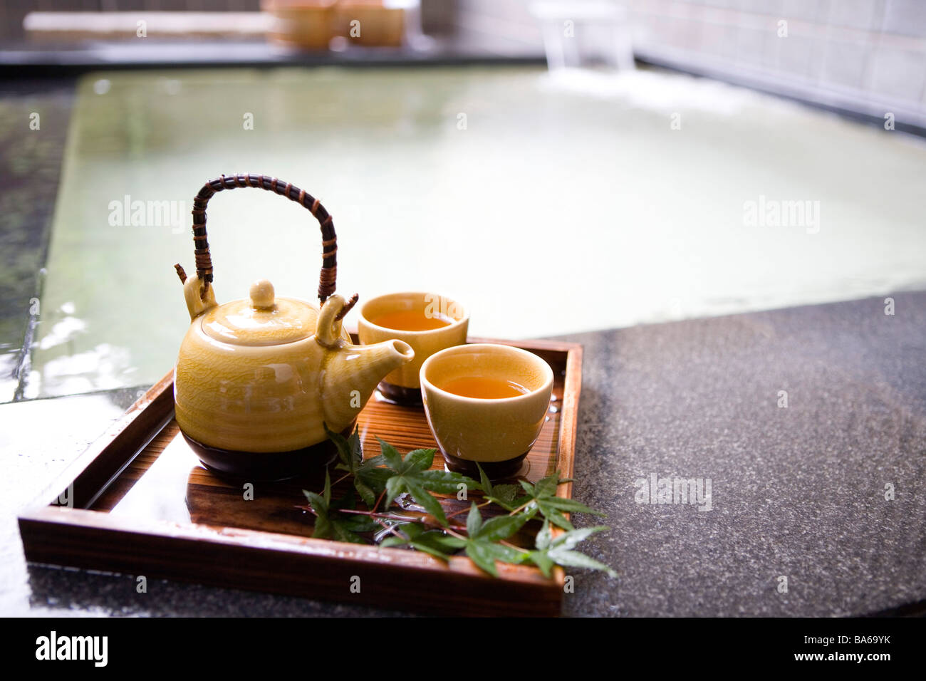 Tea set on wooden tray by pool Stock Photo - Alamy