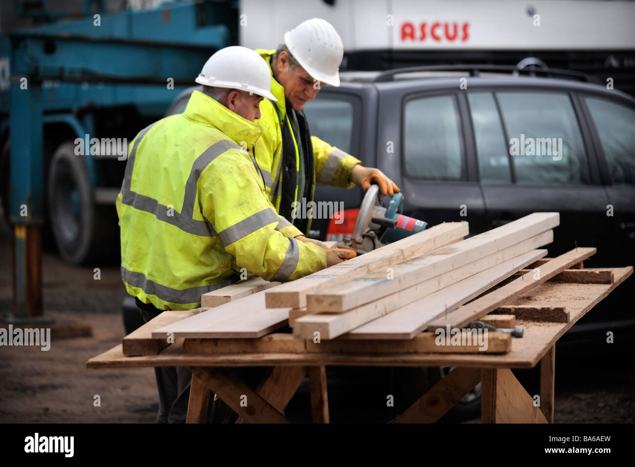 CARPENTERS MAKE WOODEN SHUTTERING BEFORE A CONCRETE DELIVERY AT OIL ...