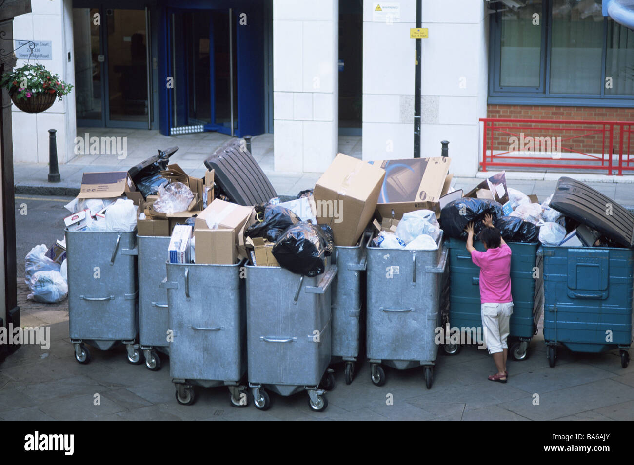 Great Britain London roadside trashcans overfills woman refuse back ...