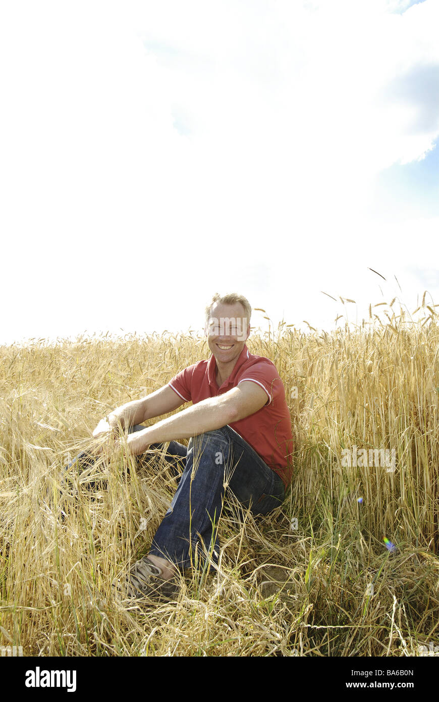 Man sits on field hi-res stock photography and images - Alamy