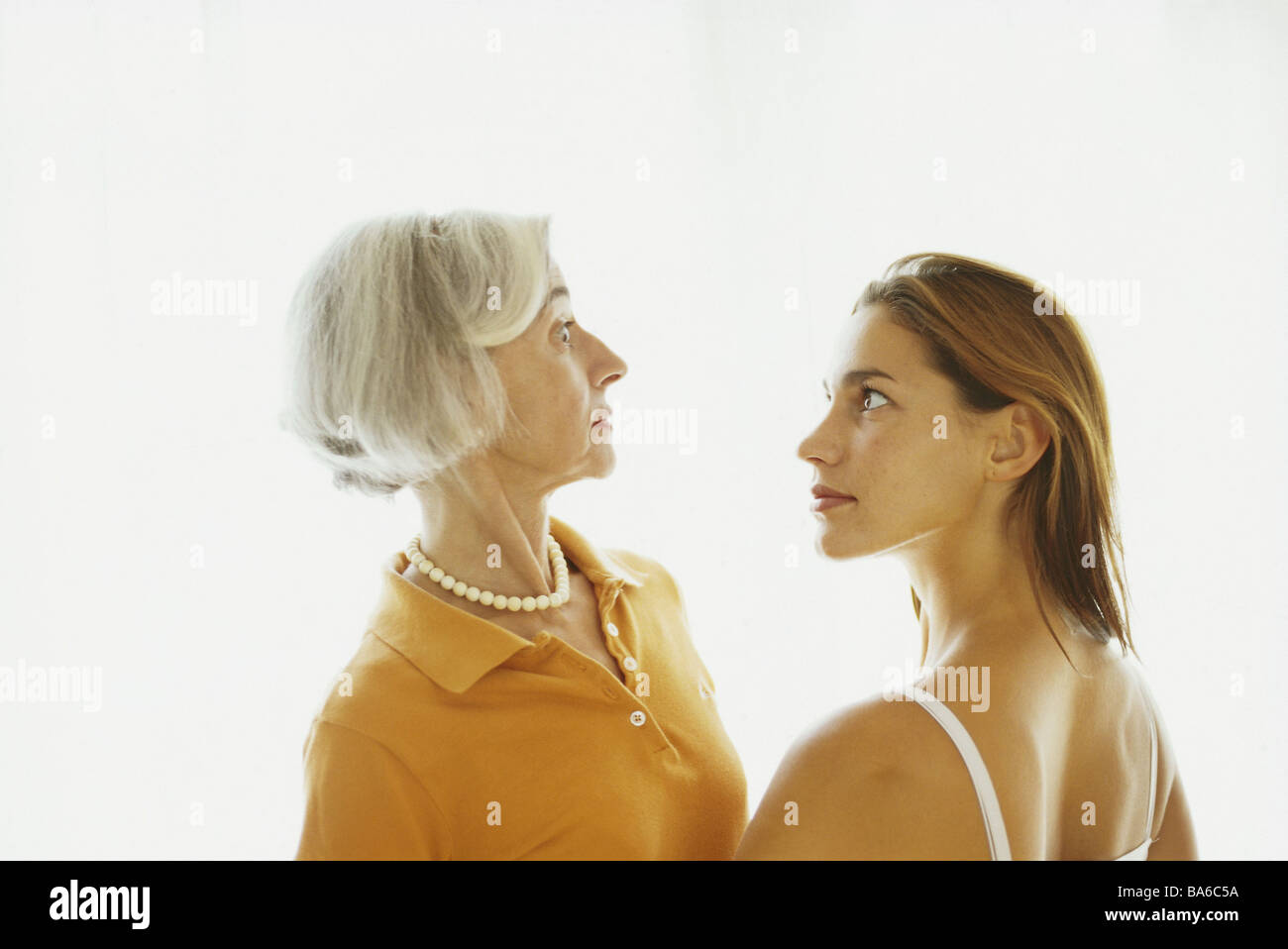 Mother daughter seriously gaze-contact side-portrait series people ... Mother daughter seriously gaze-contact side-portrait series people ...