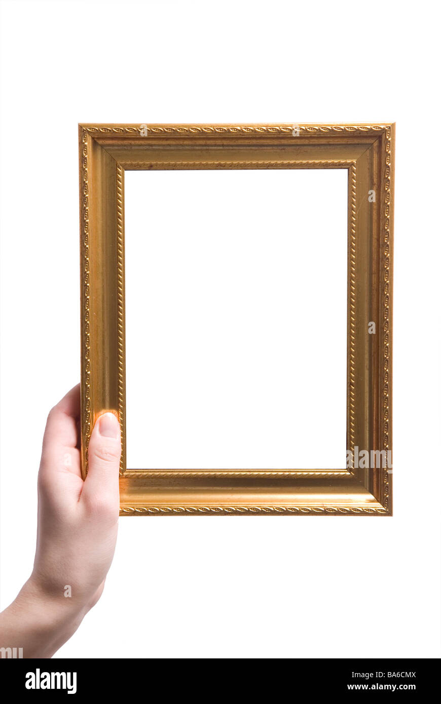 Woman's hand holding a golden photo frame Stock Photo - Alamy