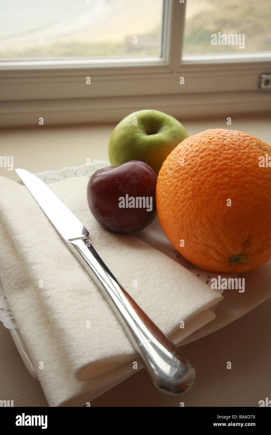 Fruit on a plate in natural light on a window sill Stock Photo - Alamy