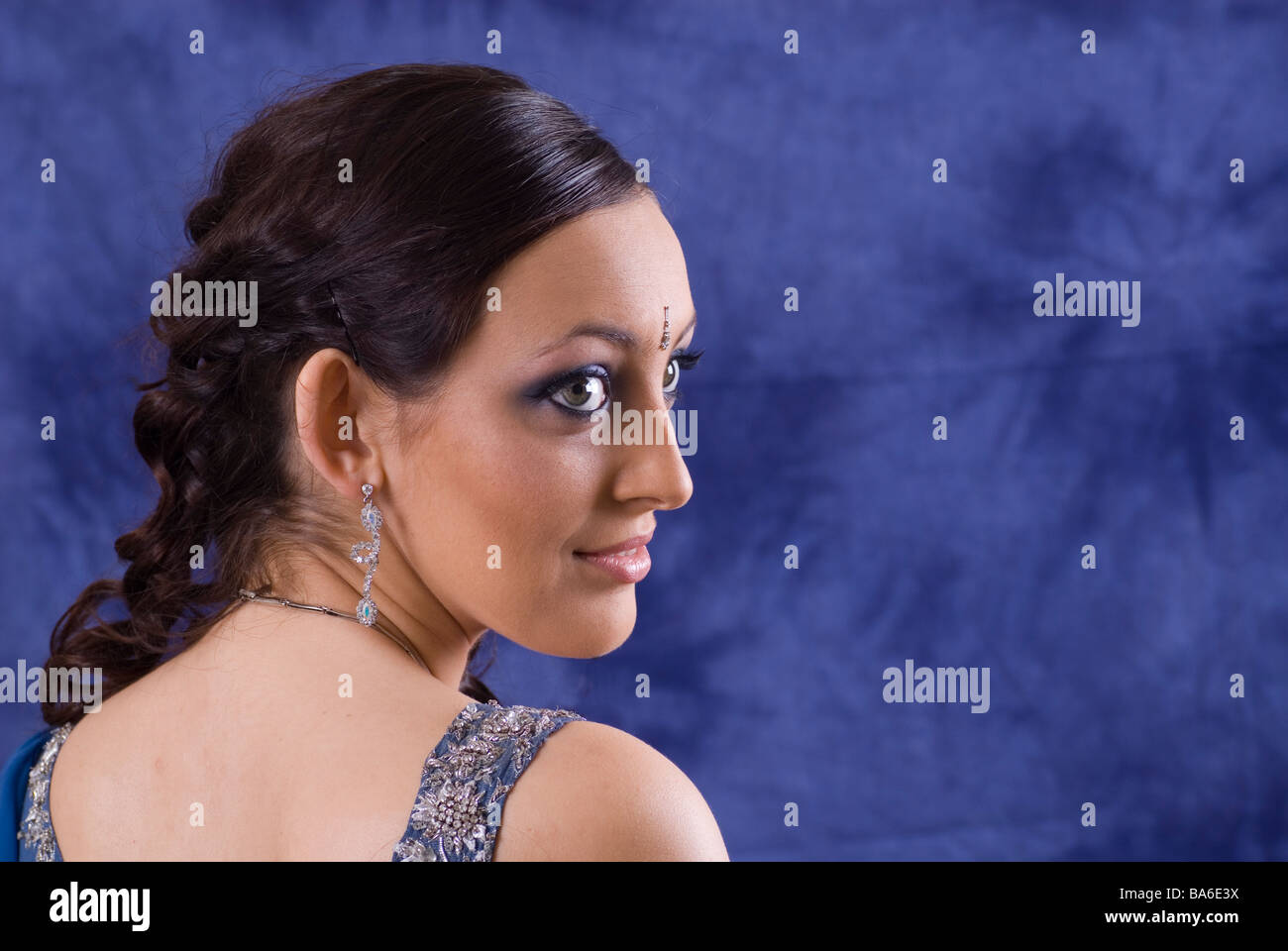 Young woman looking over shoulder Stock Photo - Alamy