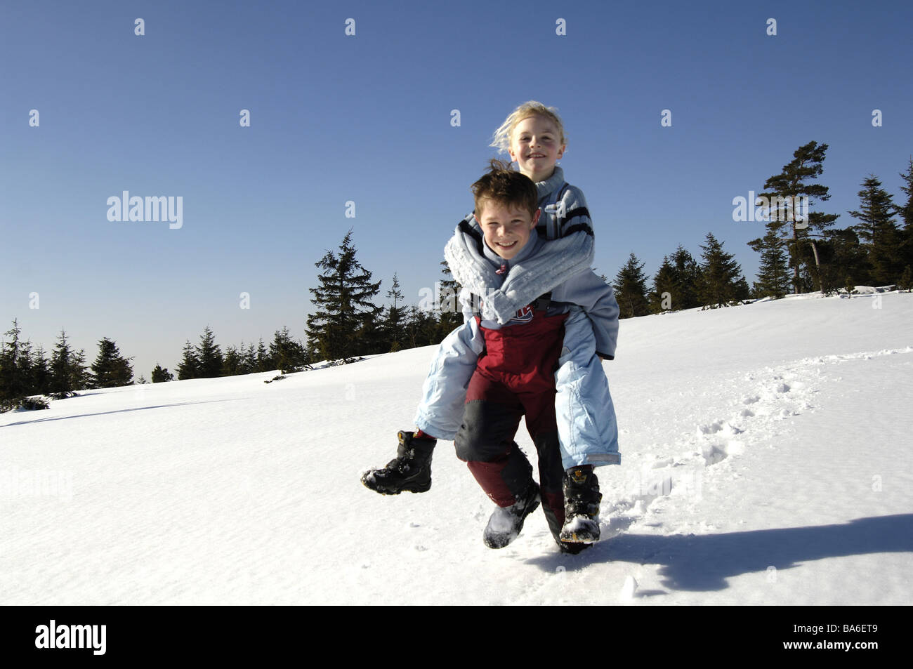 Children plays omitted brother sister carries piggyback snow winters ...