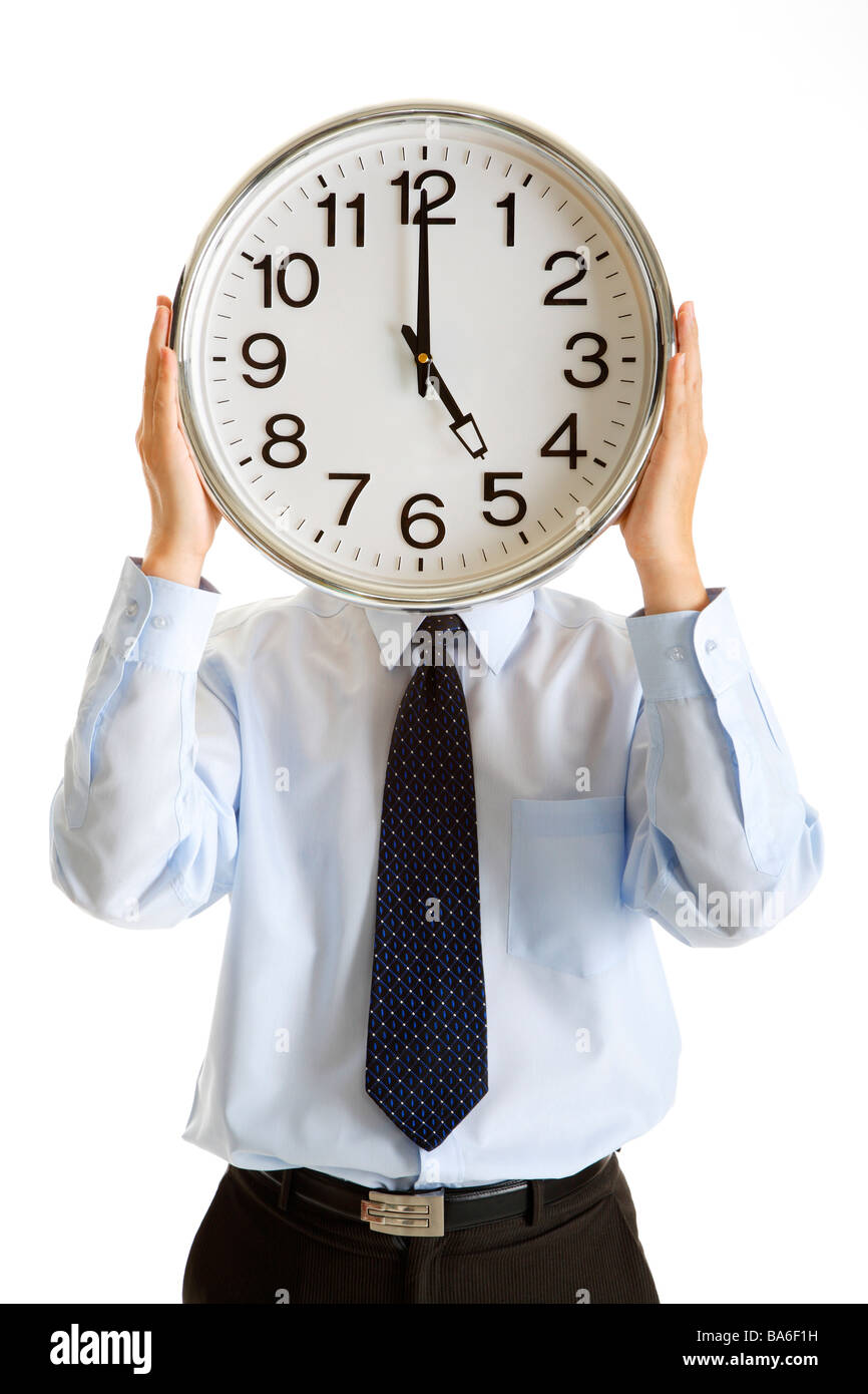 Businessman holding up clock Stock Photo - Alamy