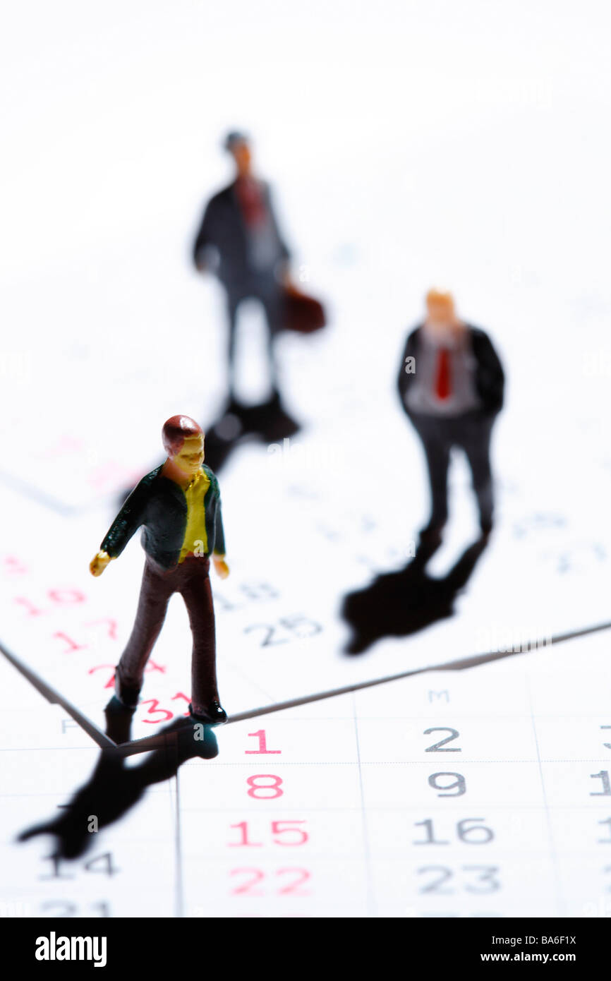 Businessman figurines standing on calendar Stock Photo - Alamy