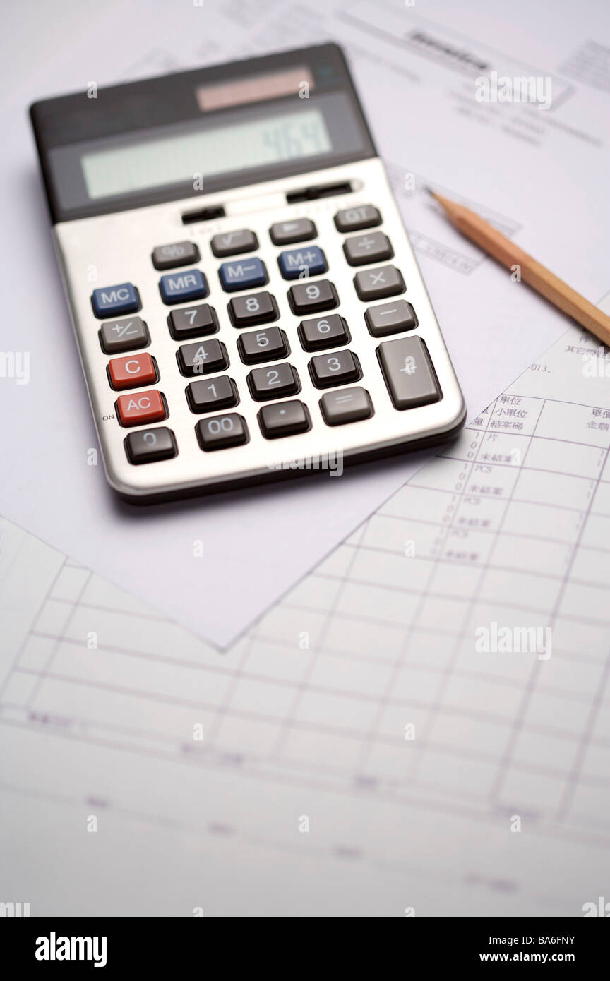 Calculator and pencil on papers Stock Photo - Alamy