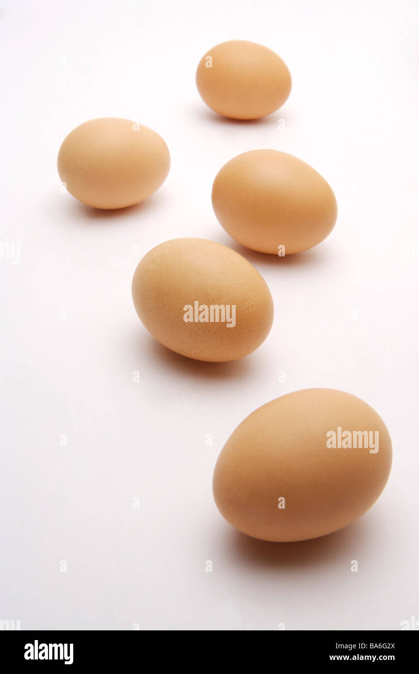 Five eggs against white background Stock Photo - Alamy