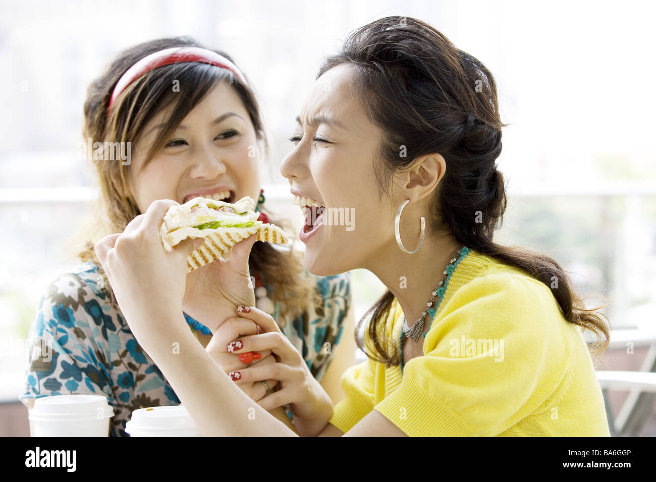 Young woman stopping her friend eating hamburger smiling portrait Stock ...