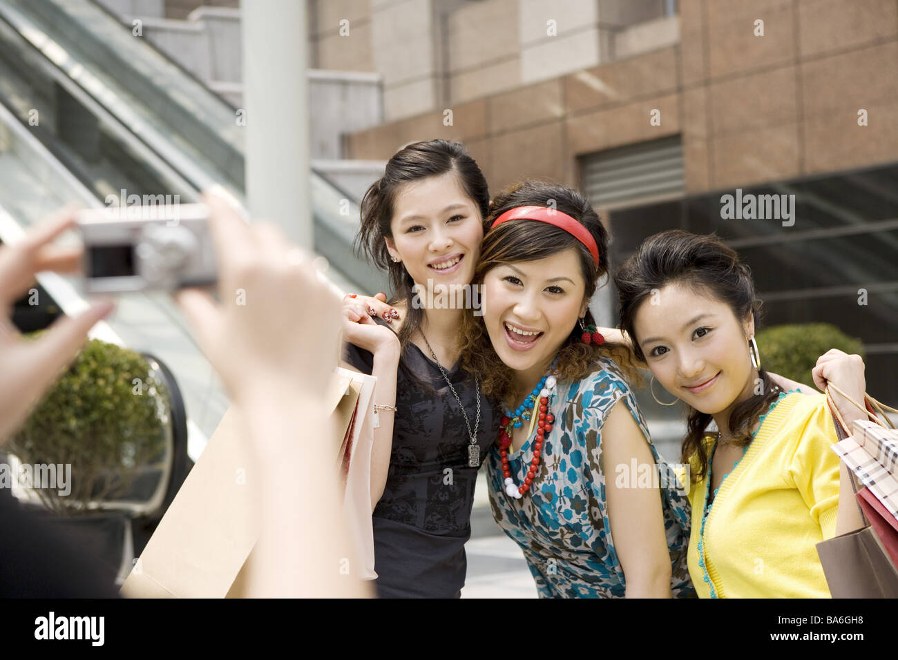 One person taking picture for three young women focus on three women ...