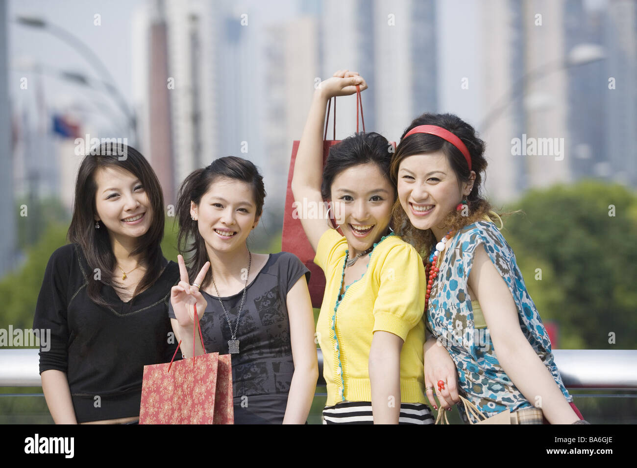 Four young women posing and smiling portrait Stock Photo - Alamy