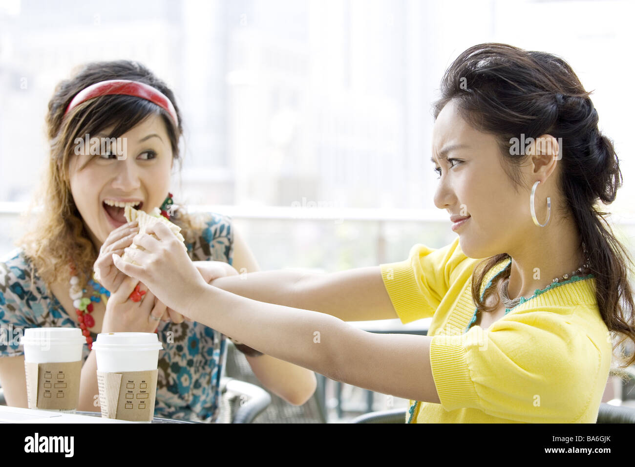 Two young women at cafe portrait Stock Photo - Alamy