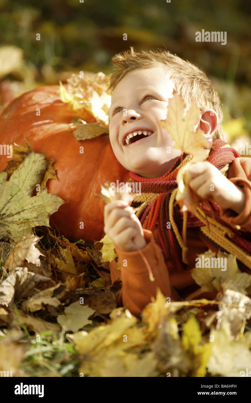 Give birth fall foliage lies pumpkin leaves plays cheerfully laughs ...