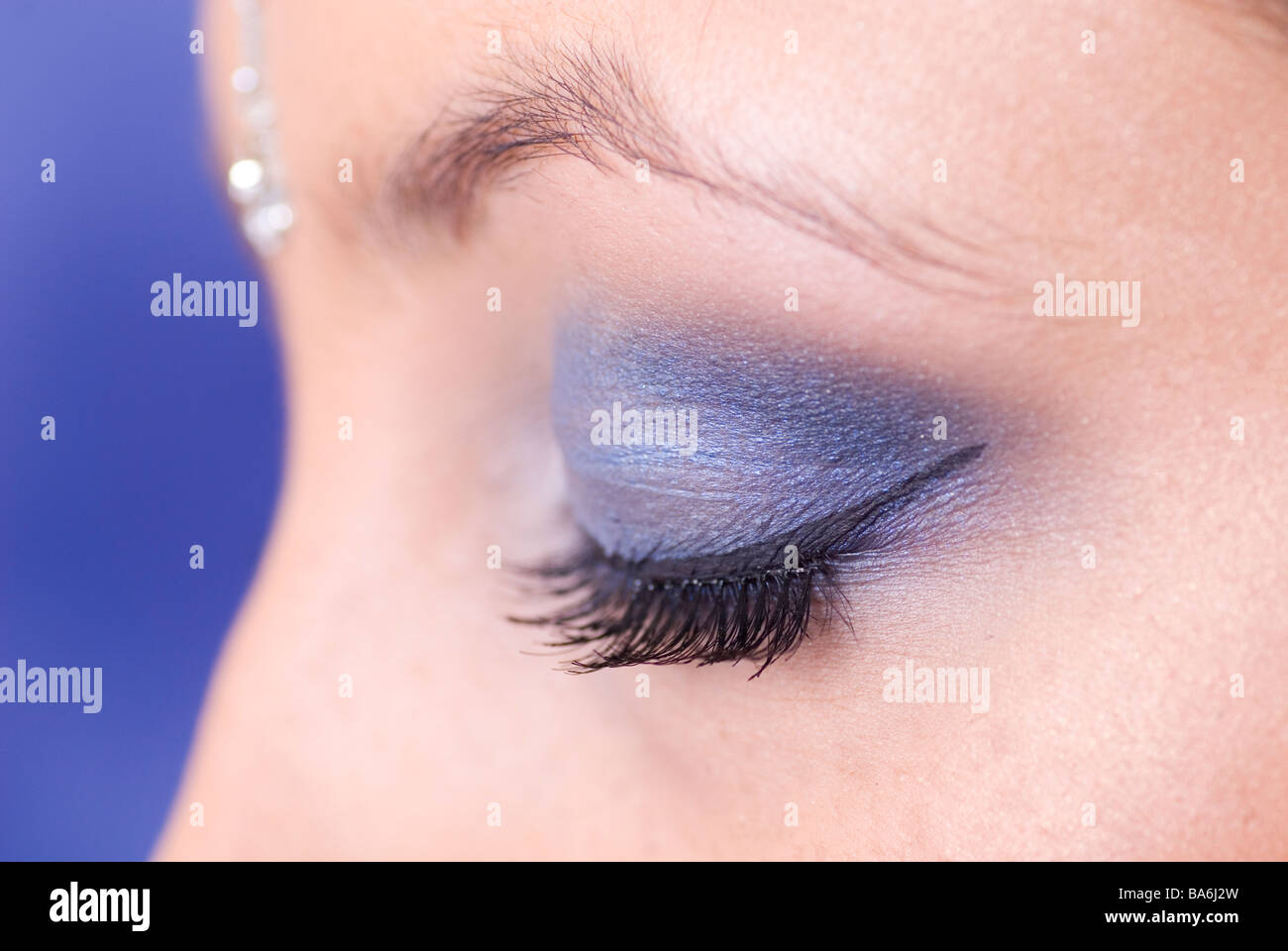 Beautiful young woman with blue eyeshadow Stock Photo - Alamy