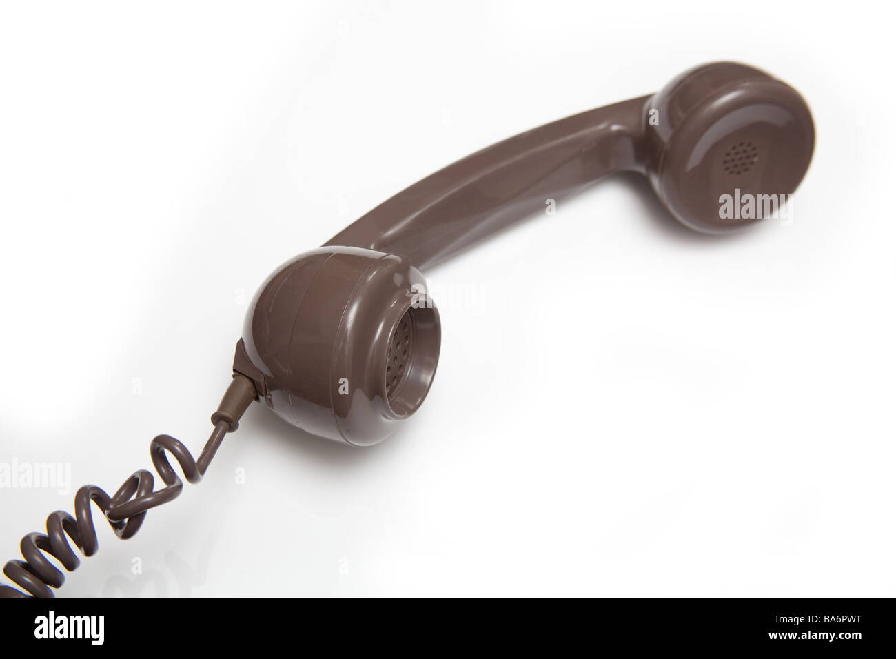 Traditional telephone receiver handset isolated on a white studio ...
