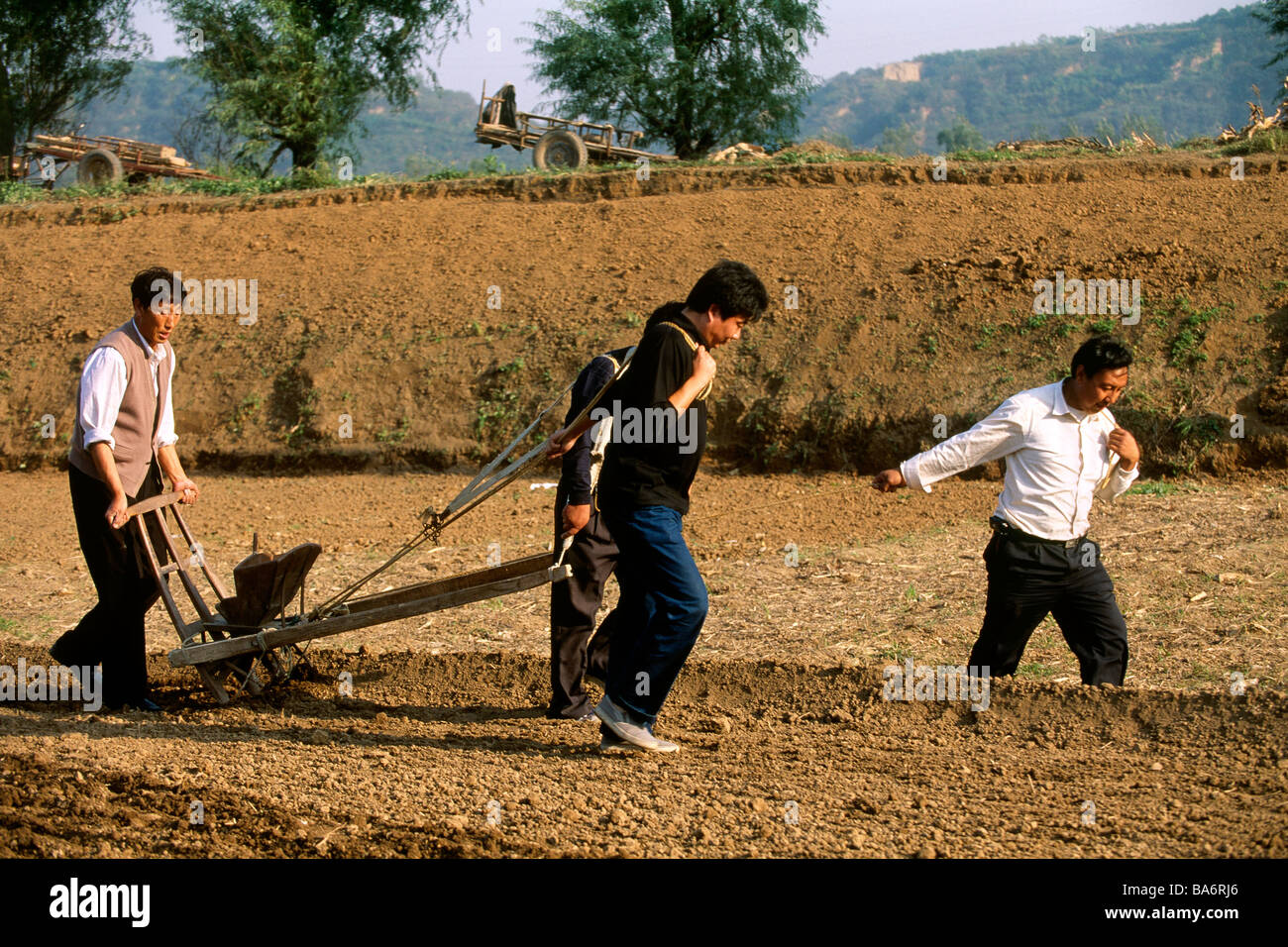 China, Henan province, Gongyi region, men pulling plough Stock Photo ...