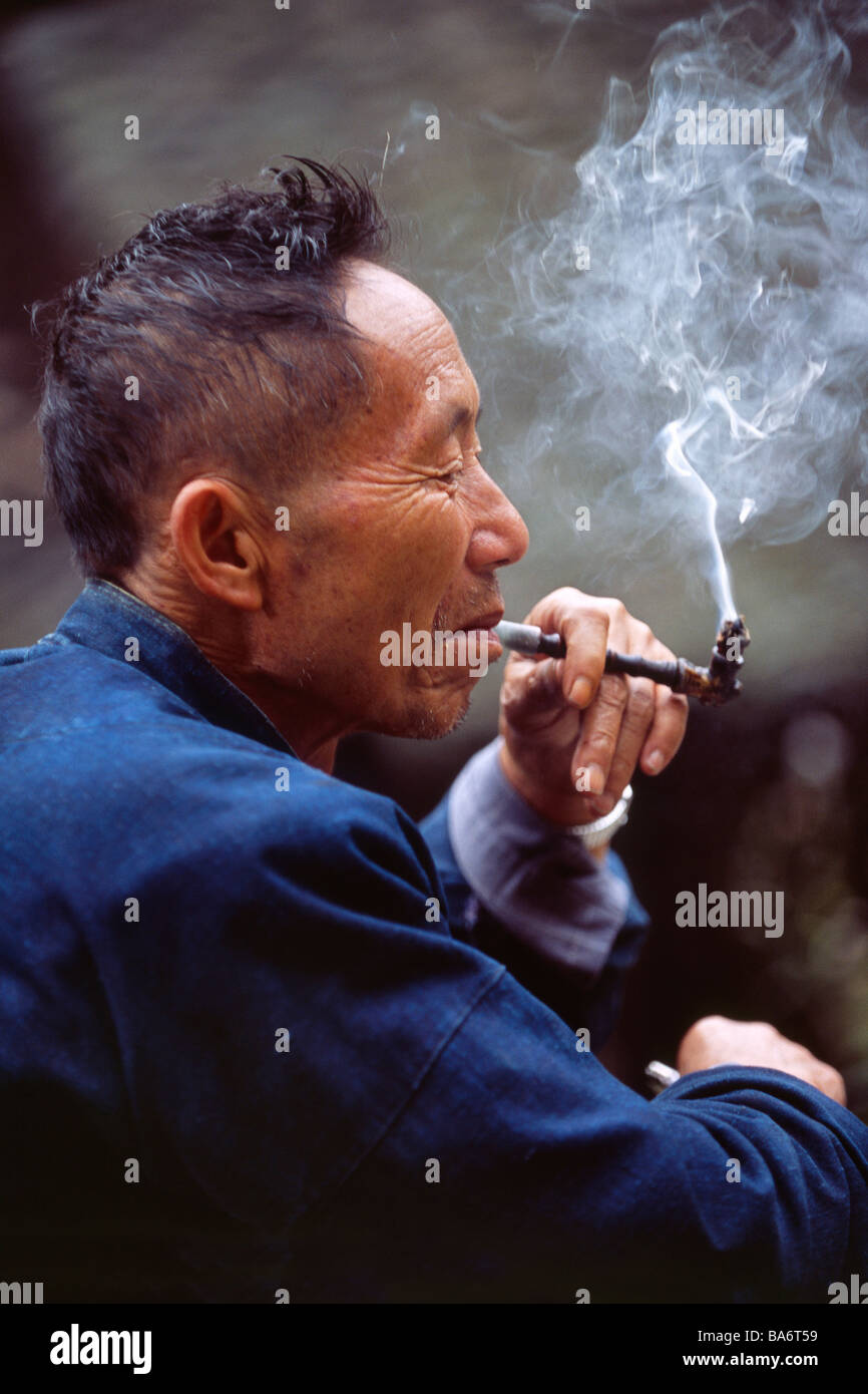 China, Guizhou province, Langde, Miao elder smoking a pipe Stock Photo ...