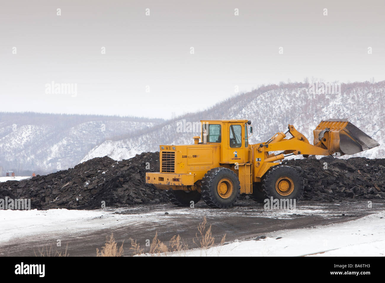 Loading coal onto a train from an open cast coal mine near Heihe on the ...