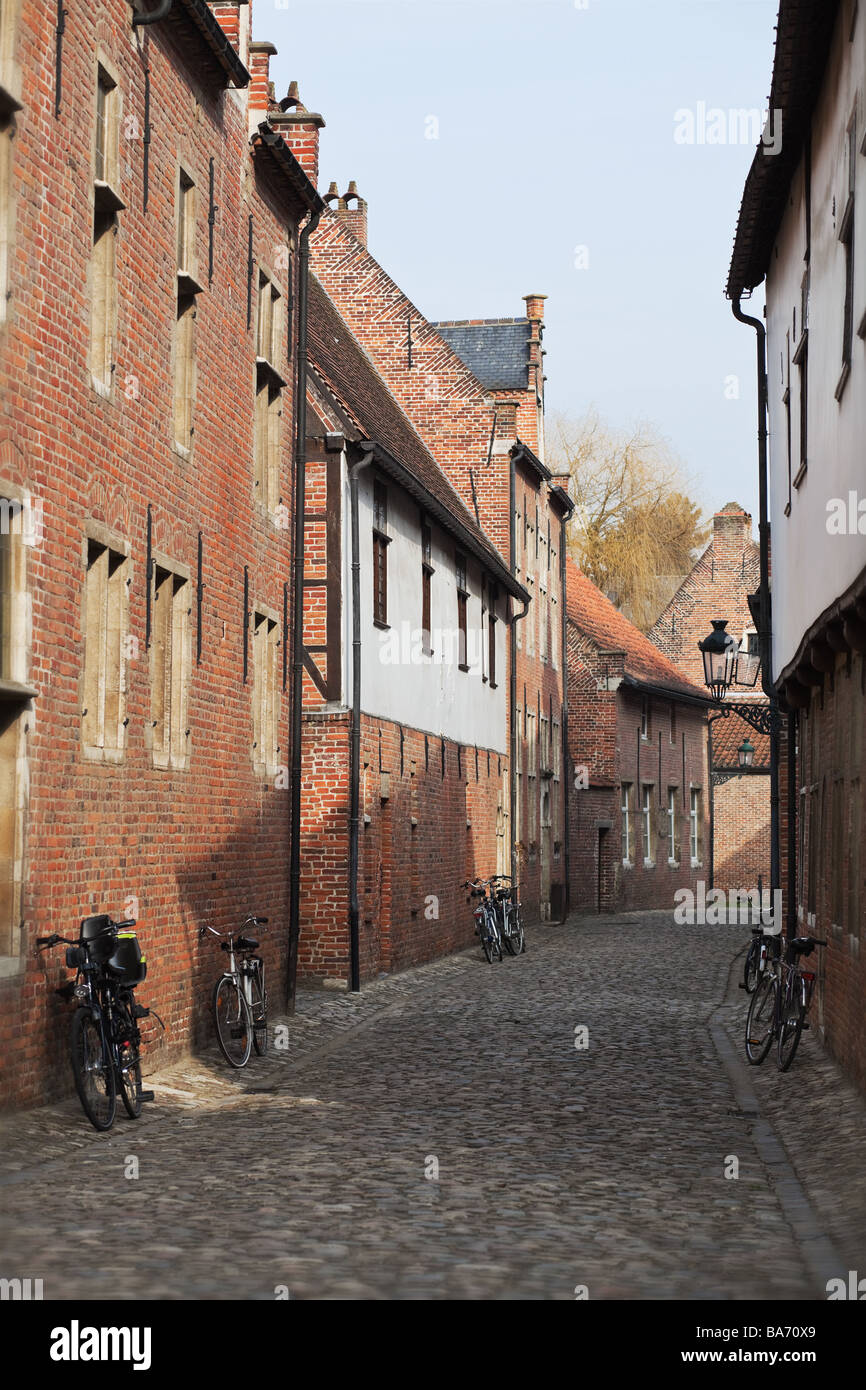 Bicycle leaned to a wall of brick medieval house cobblestone pavement ...