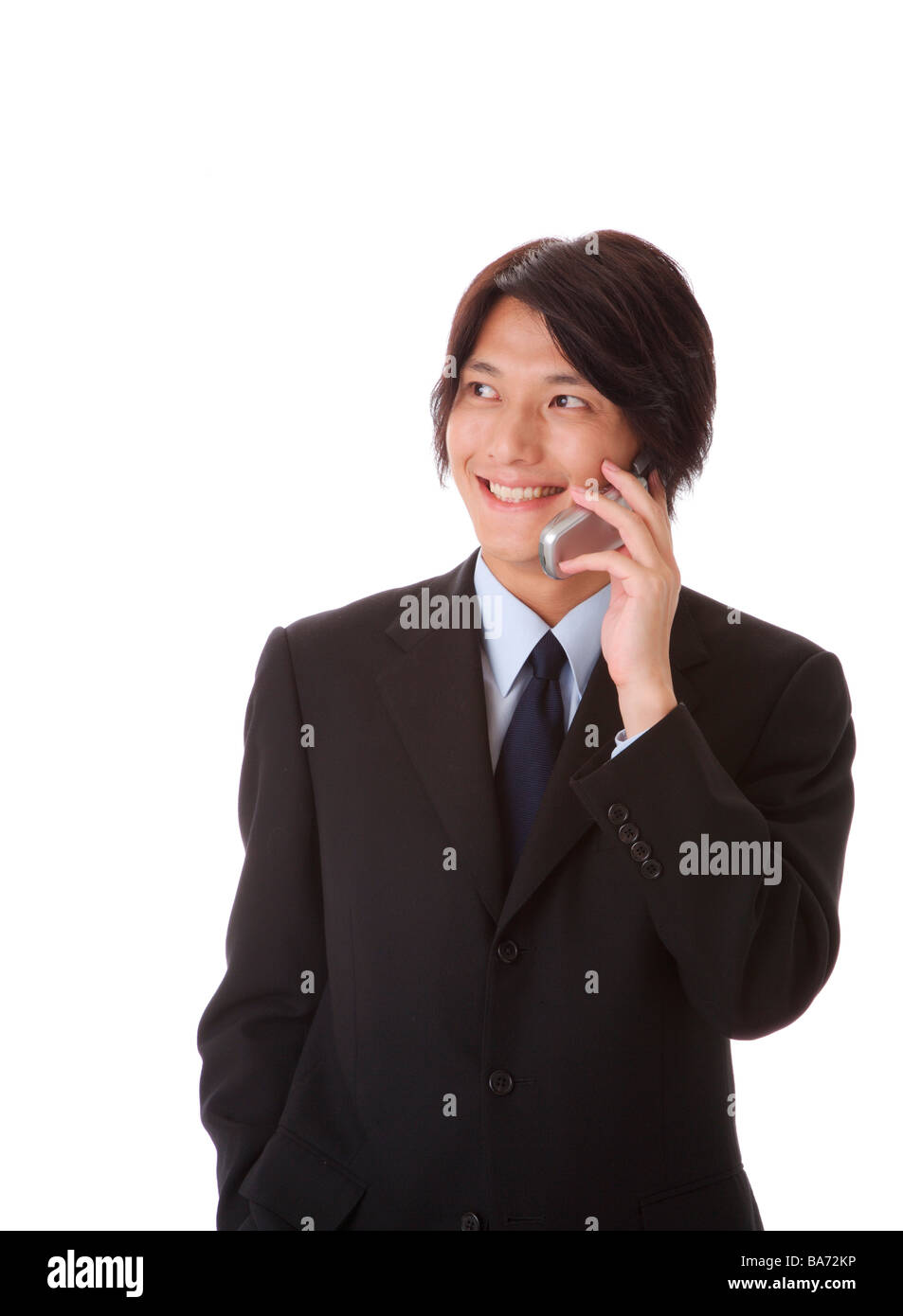 Businessman using cell phone smiling Stock Photo - Alamy