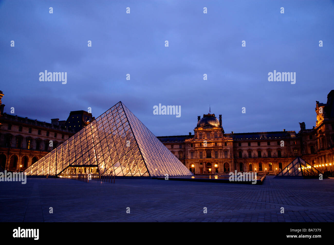 Illuminated Louvre Museum and Louvre Pyramid at night Paris Stock Photo ...