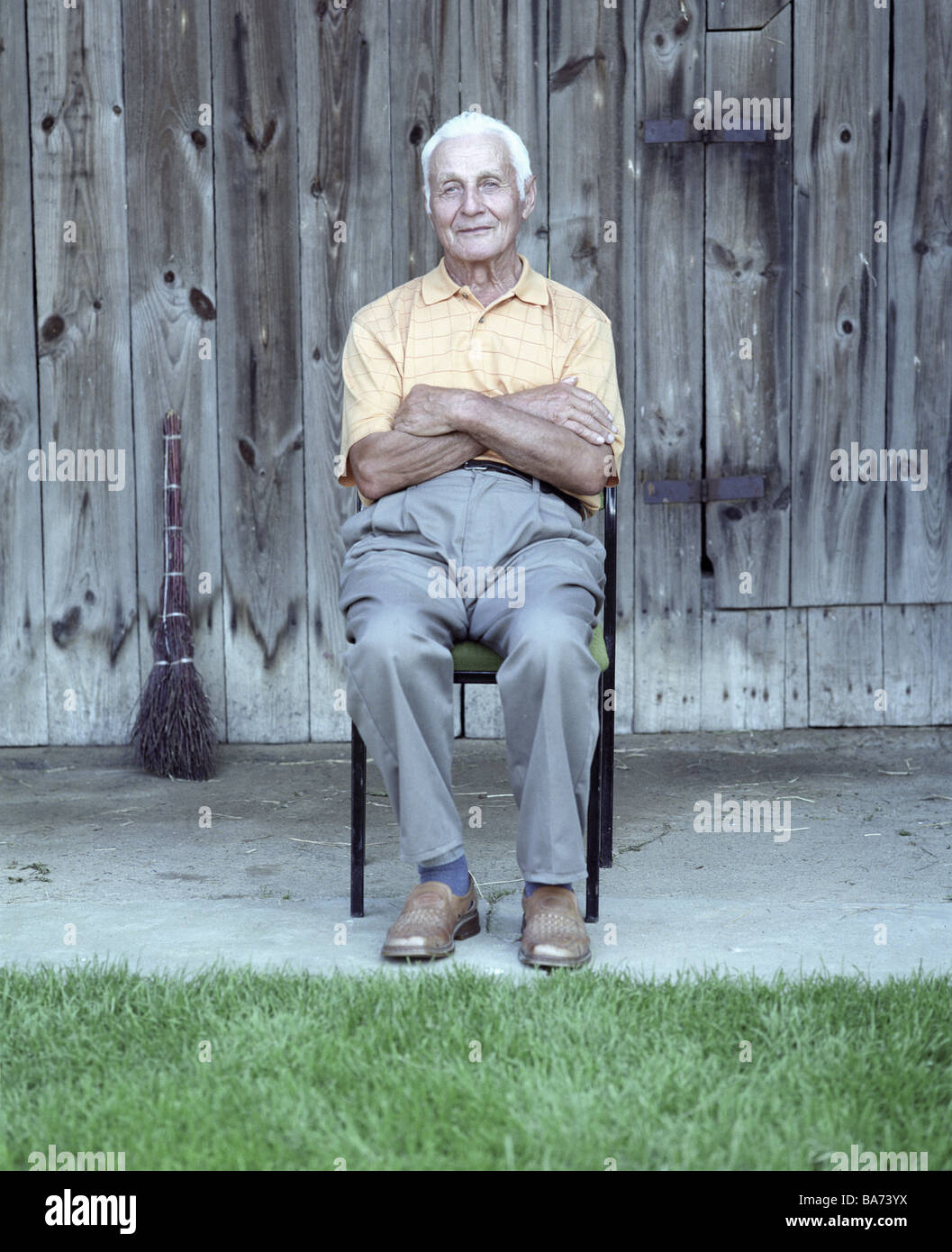 Senior poor chair crosses sits people outside 80 years 80-90 years ...